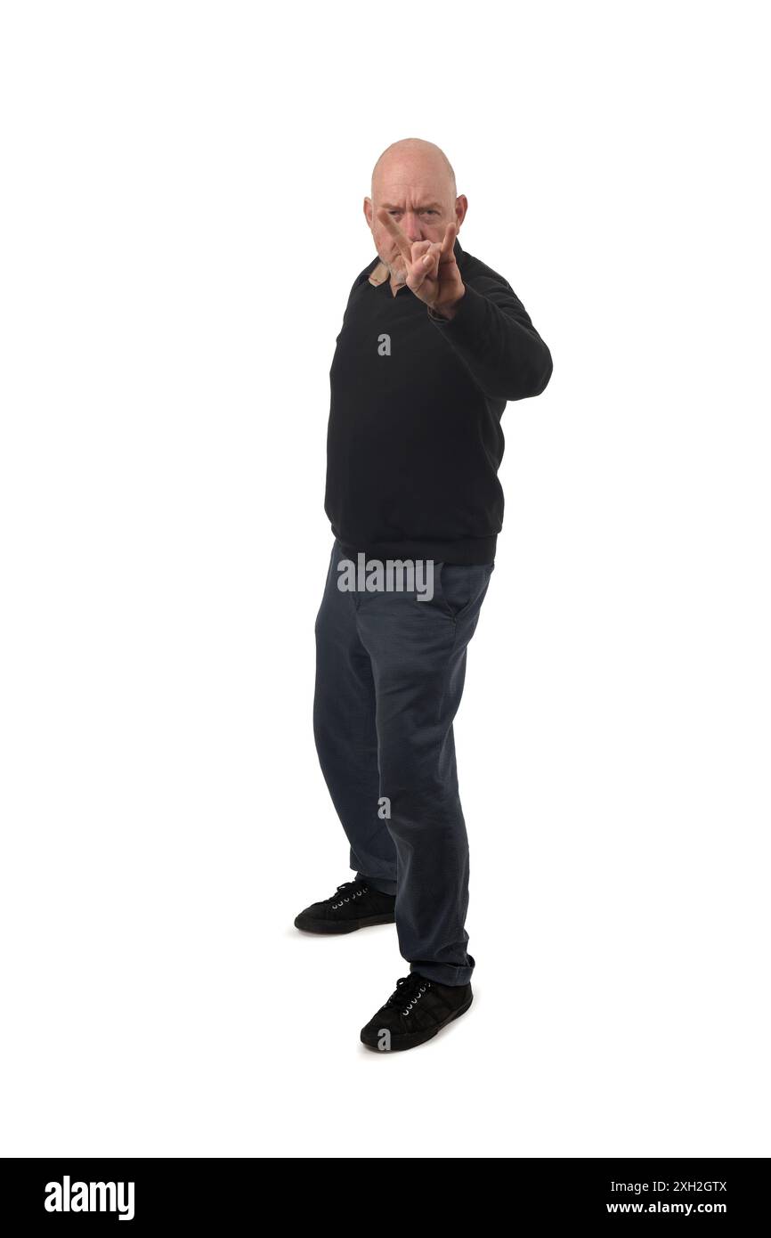 front view of a man showing the horns sign with fingers on white ...