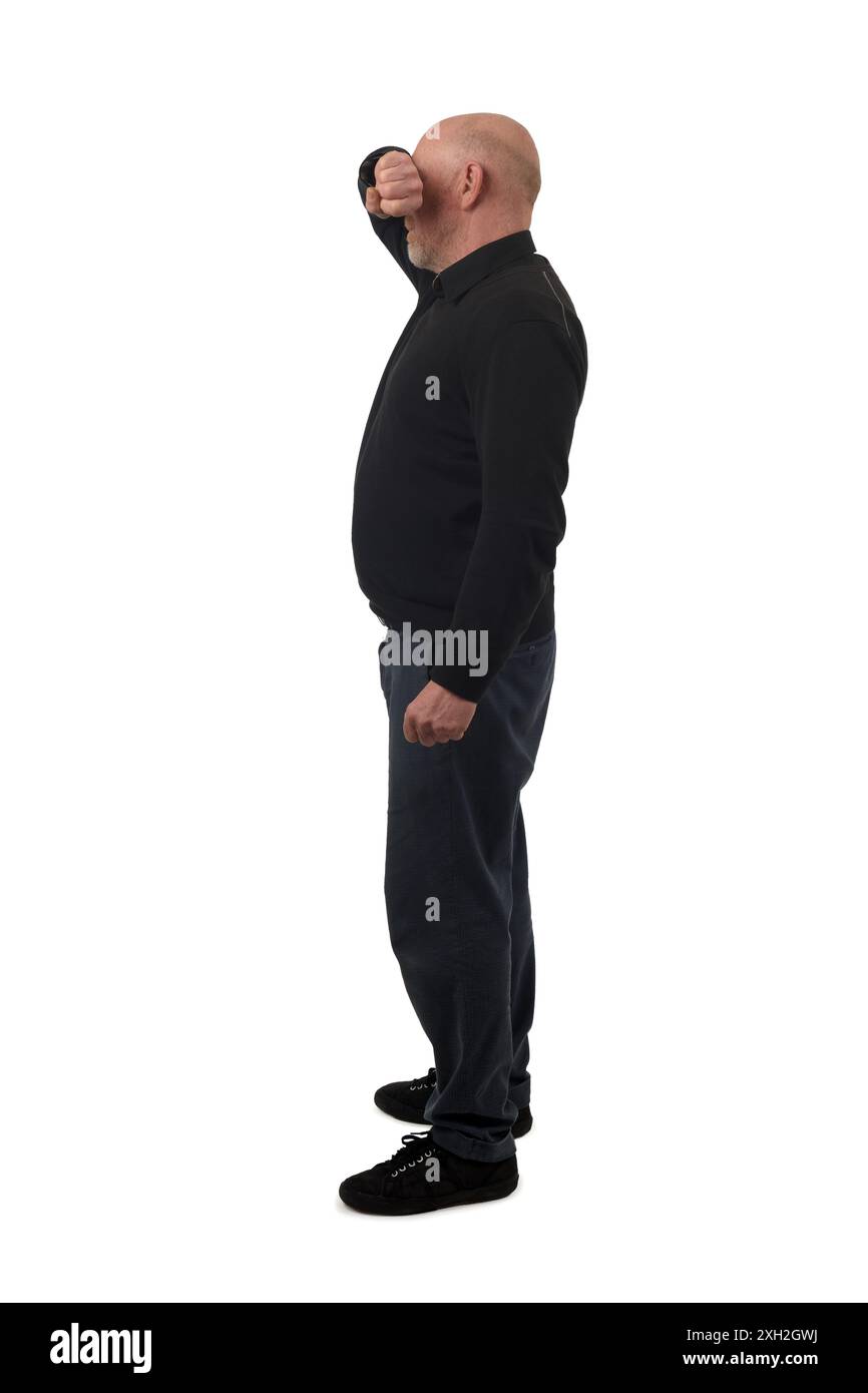 side view of a man covering her face with her arm on white background ...
