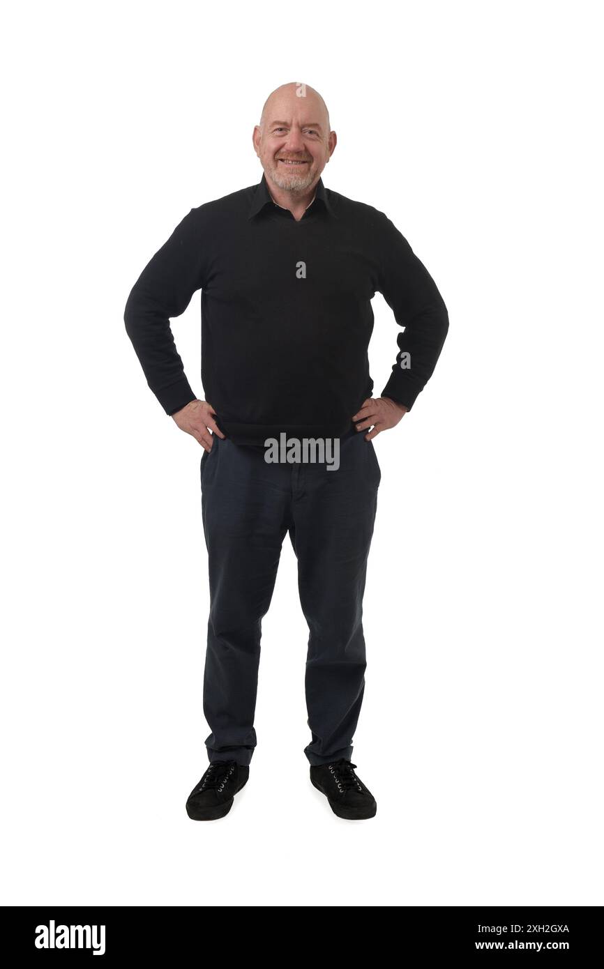 front view of man looking at camera and arms akimbo on white background ...