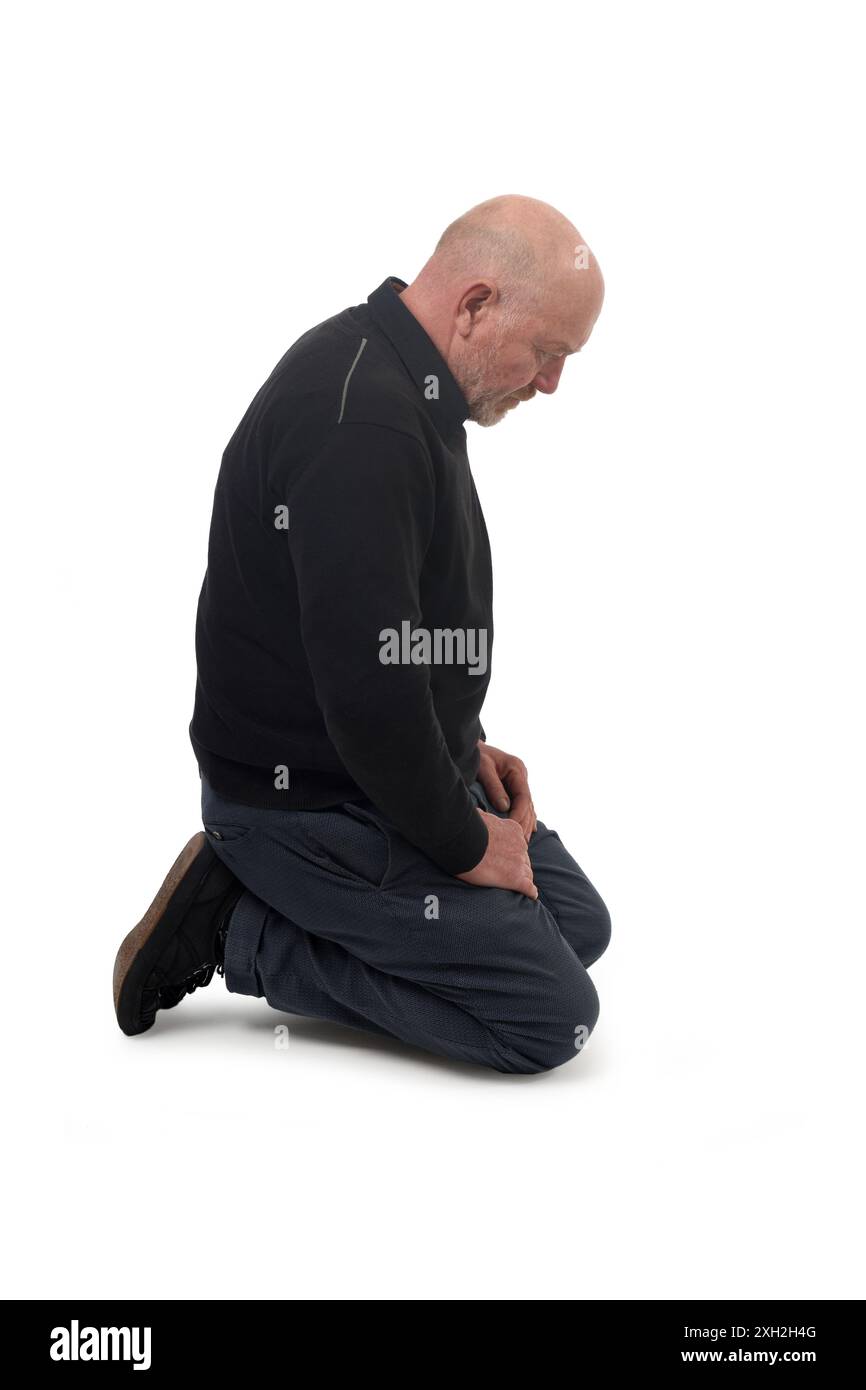 side view of a man kneeling on the floor in white background Stock ...