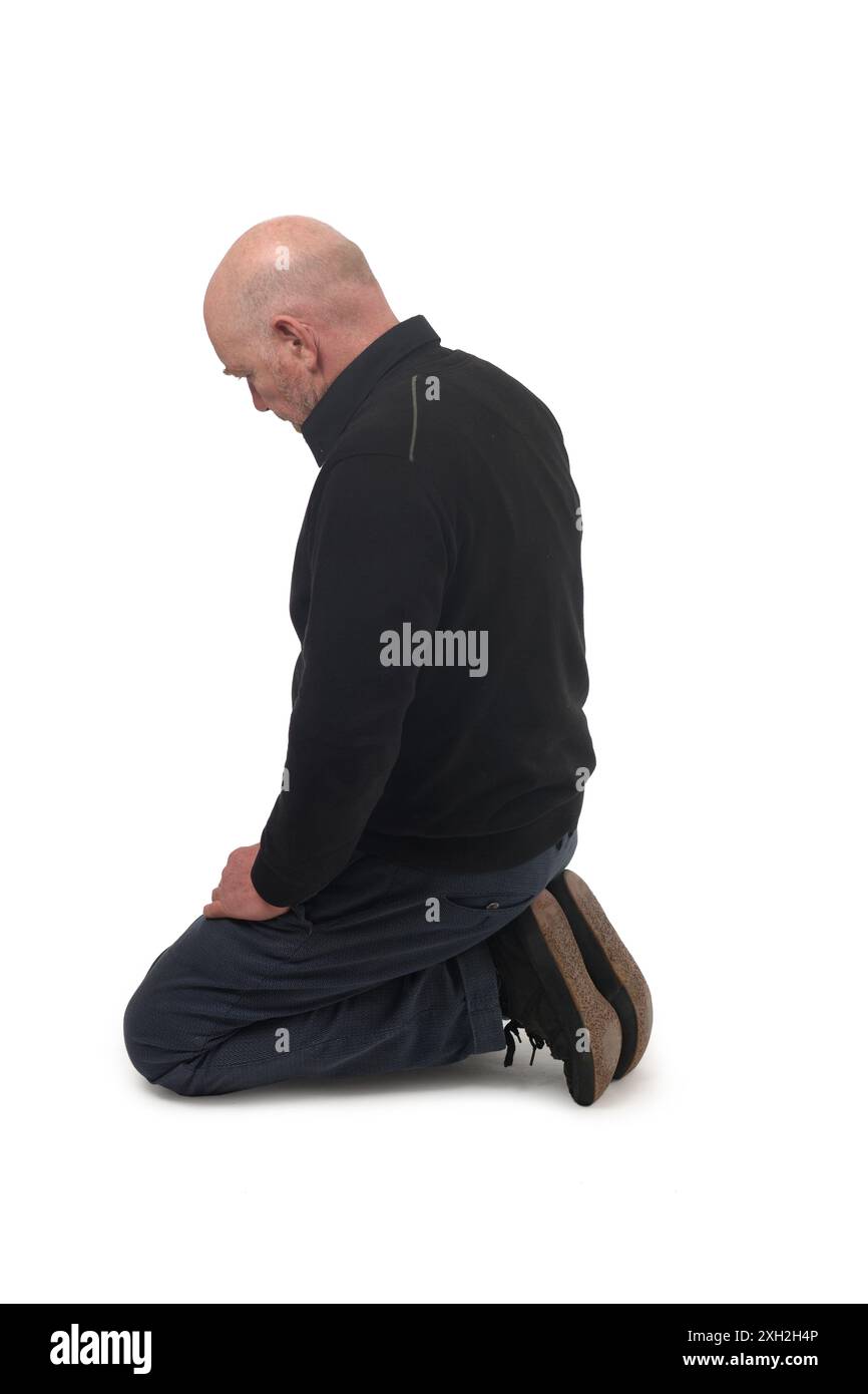 side view of a man kneeling on the floor in white background Stock ...
