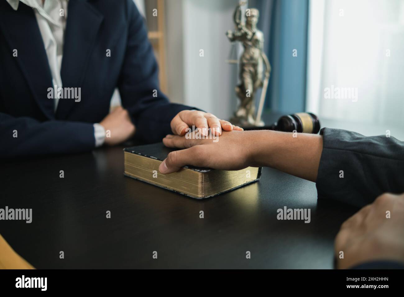 A Bible is placed on the table in the law office so that the defendant ...