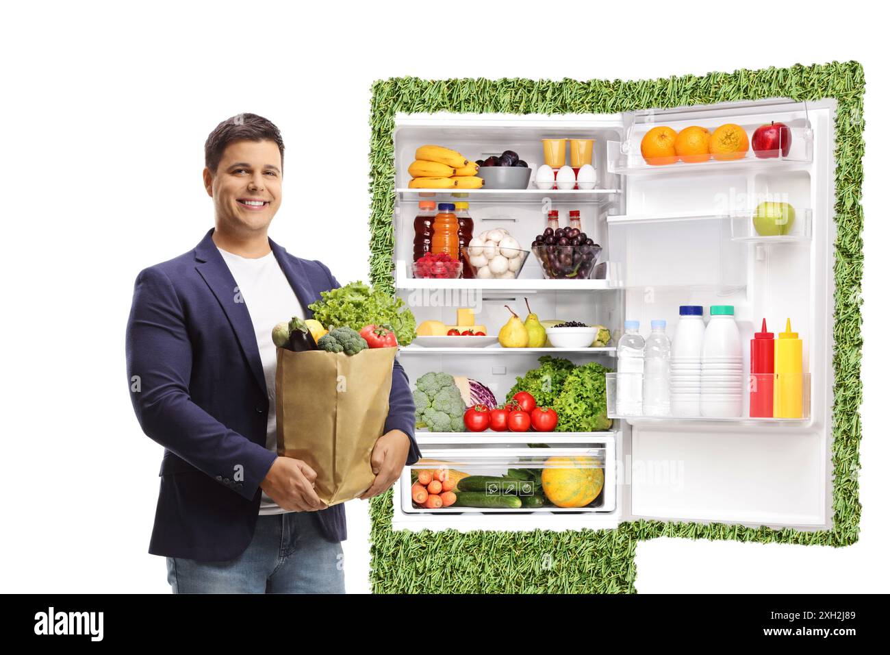 Young man with a grocery bag and eco friendly fridge isolated on white ...