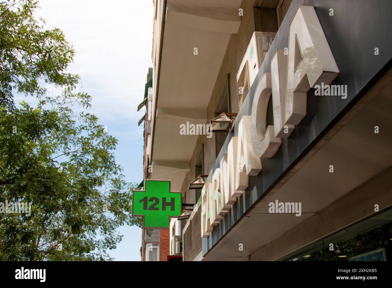 Pharmacy indication sign, a luminous green cross that indicates that a ...