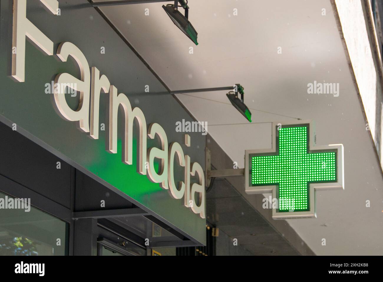 Pharmacy indication sign, a luminous green cross that indicates that a ...