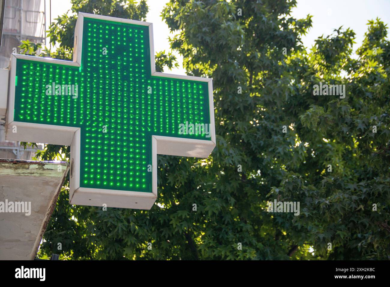 Pharmacy indication sign, a luminous green cross that indicates that a ...