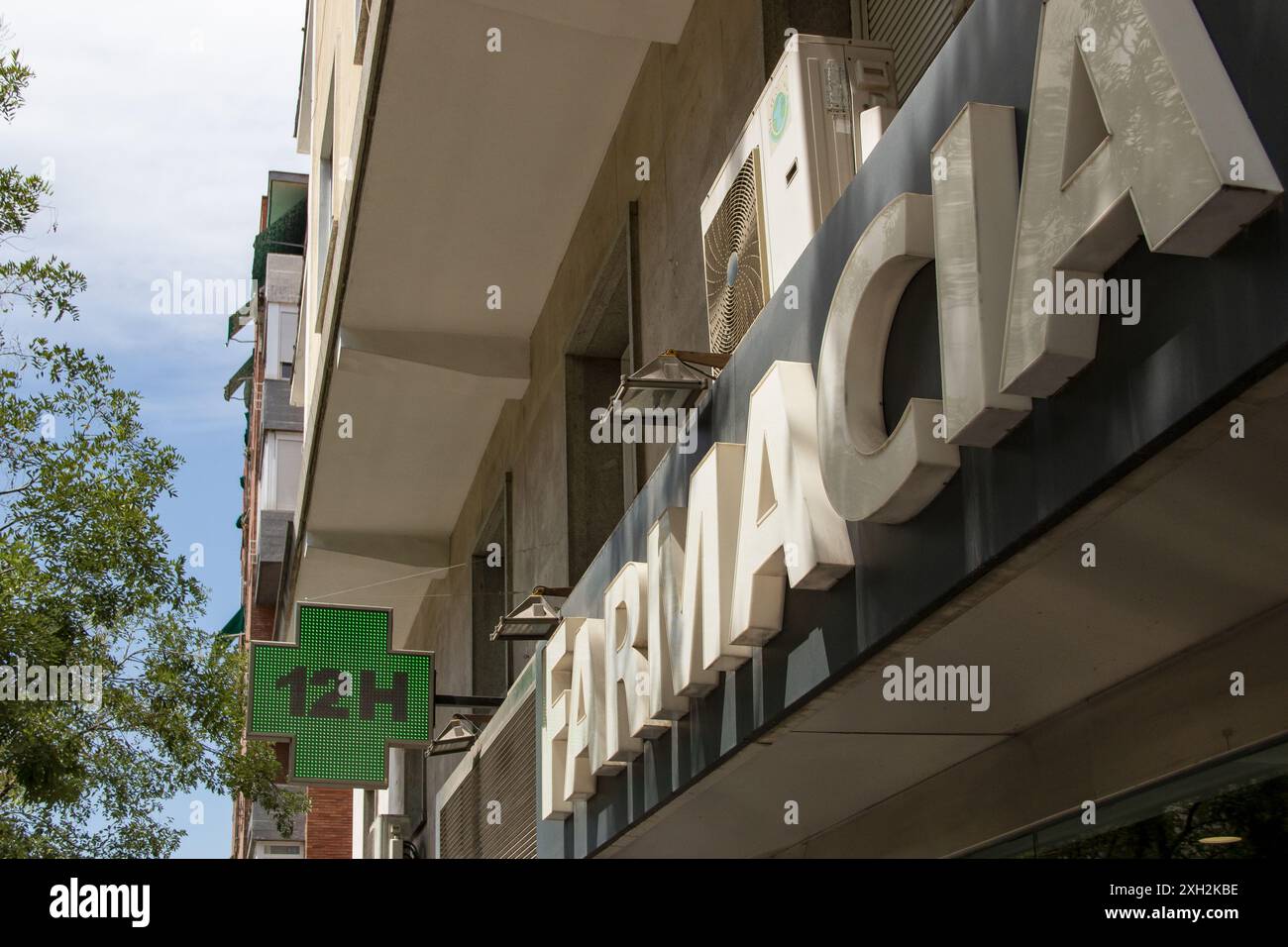 Pharmacy indication sign, a luminous green cross that indicates that a ...