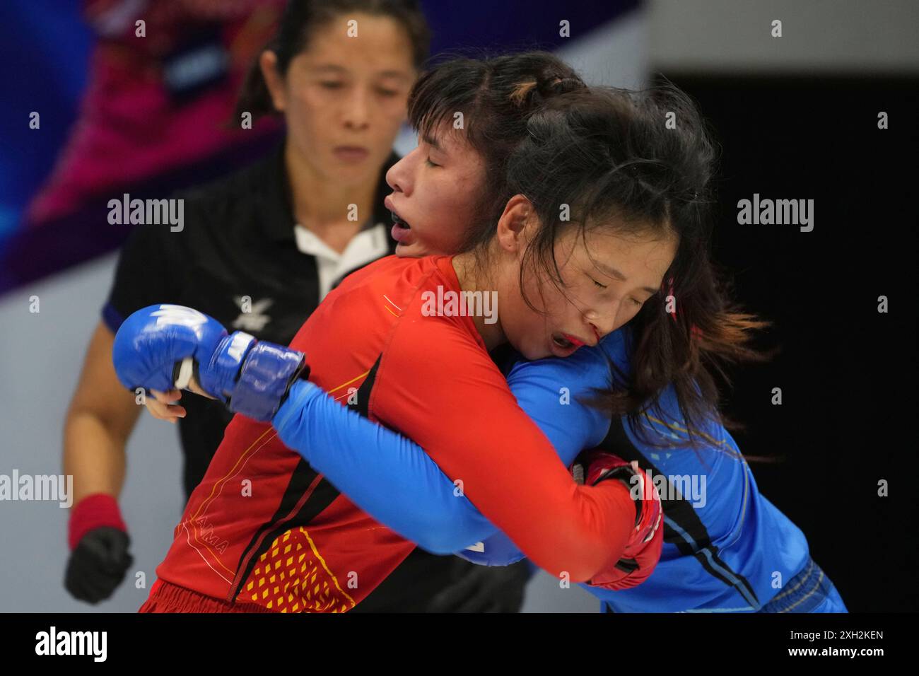 Holly Kwan of Hong Kong, front, competes with Bo Mi Lee of South Korea ...