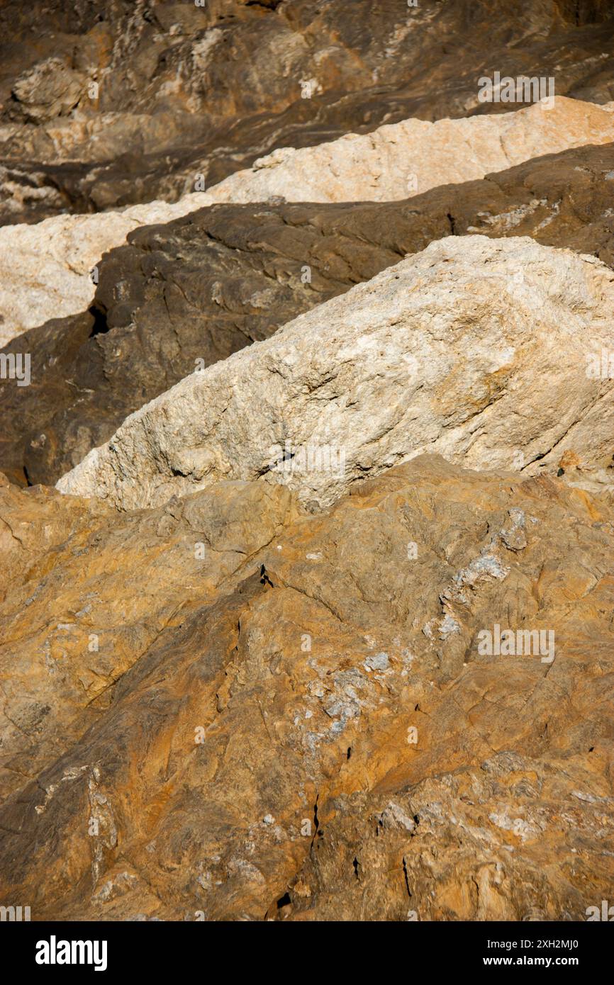Ocher-colored rocks forming a kind of wave as they are placed in such a ...