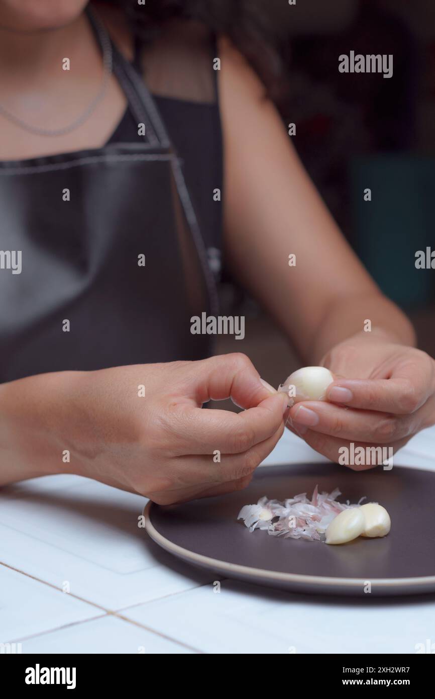 Woman peeling garlic hand on hi-res stock photography and images - Alamy