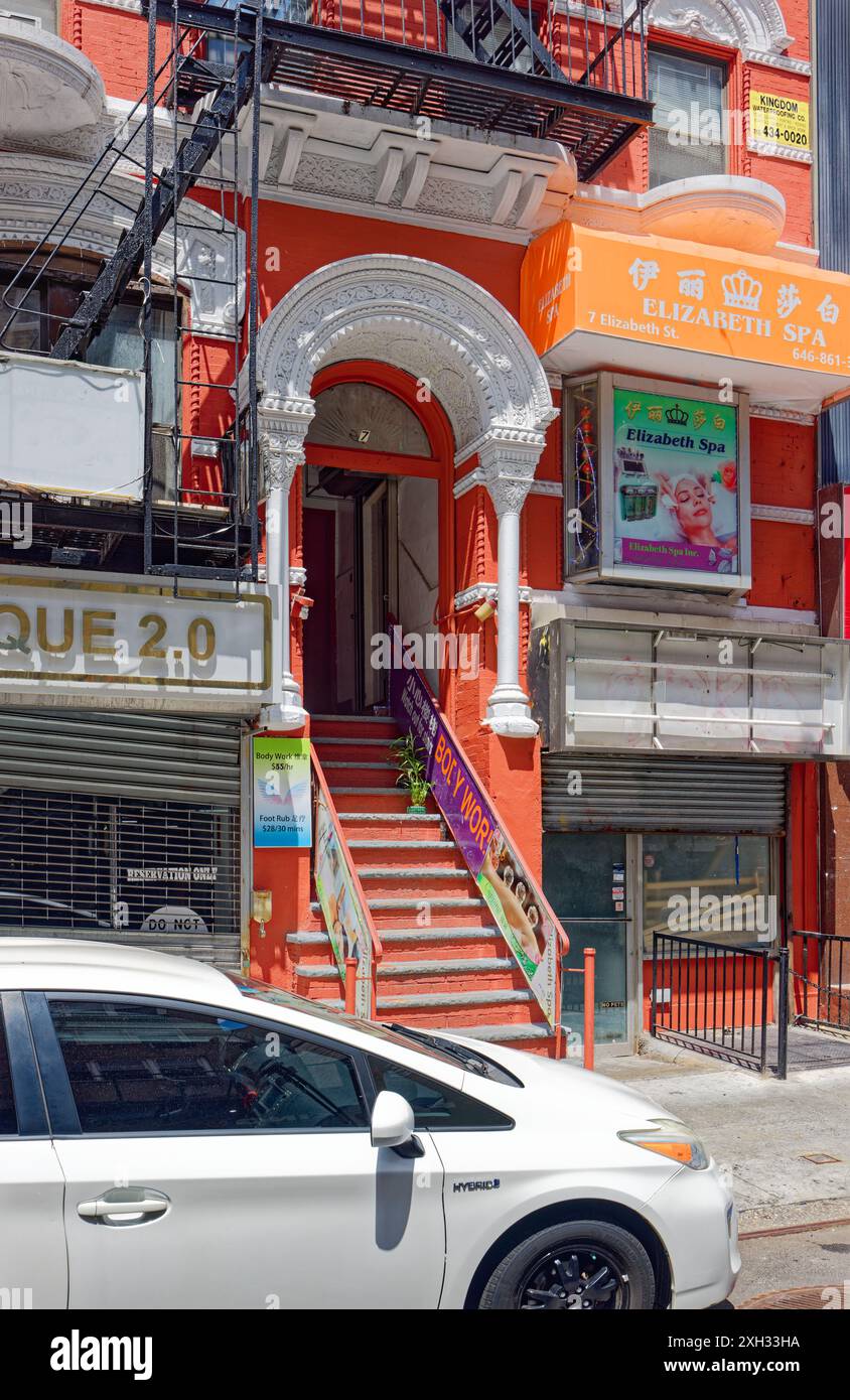 NYC Chinatown: White painted terra cotta arch and columns surround ...