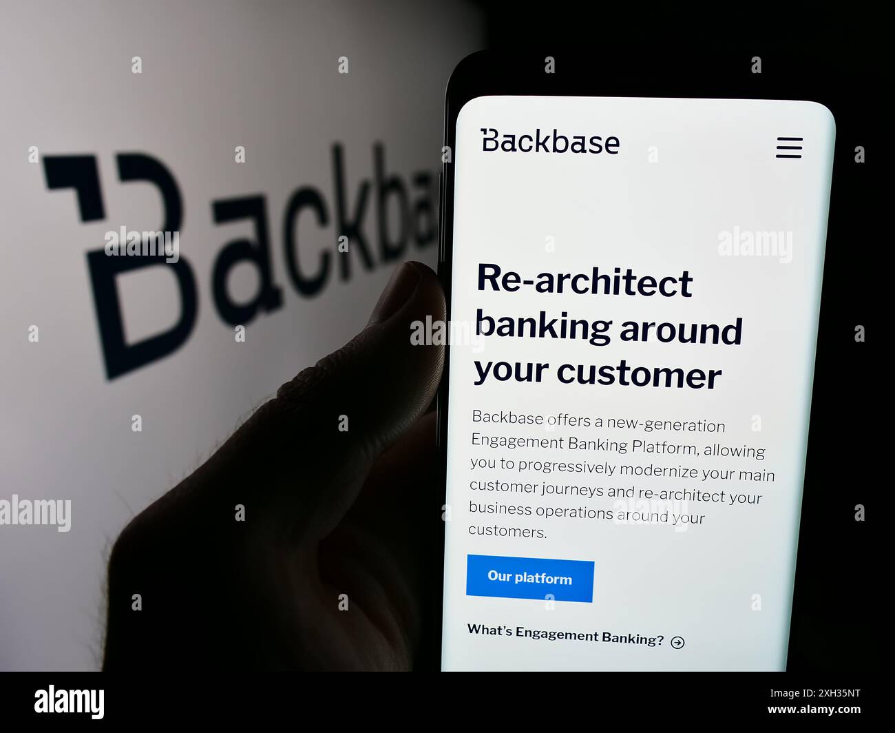 Person holding smartphone with webpage of Dutch fintech company ...