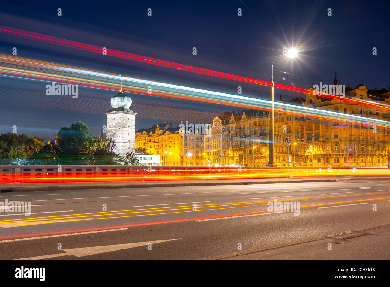 A long exposure photograph captures the vibrant lights of Prague at ...