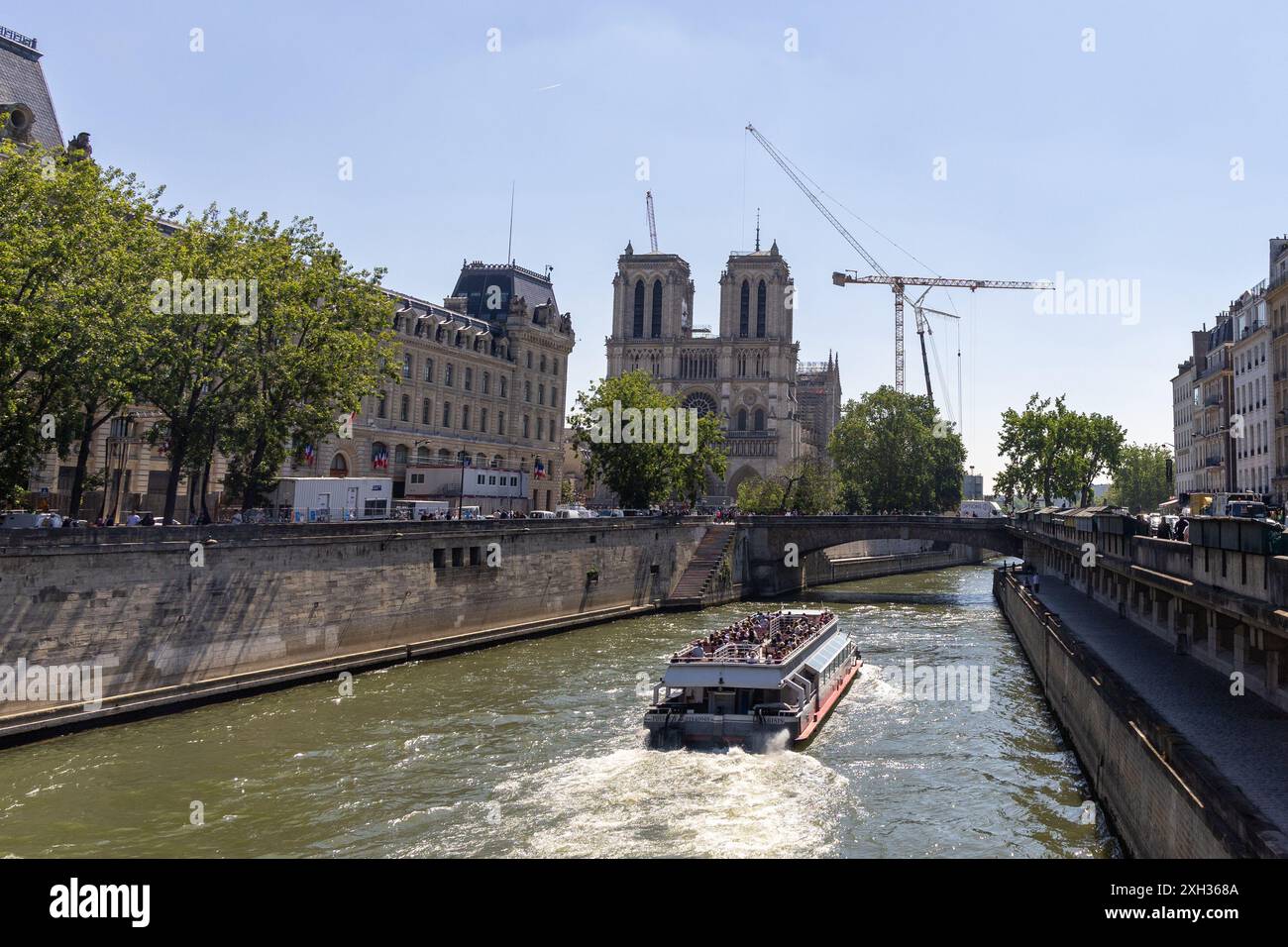 Paris, France - June 07 2024:Tourist boat on river Seine approaching ...