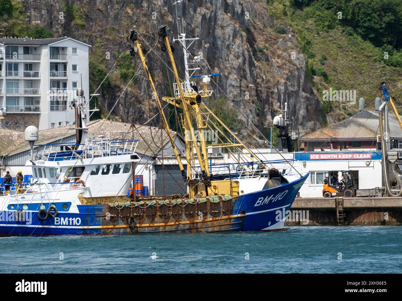 A deep sea fishing trawler returning to port with its catch in Brixham ...