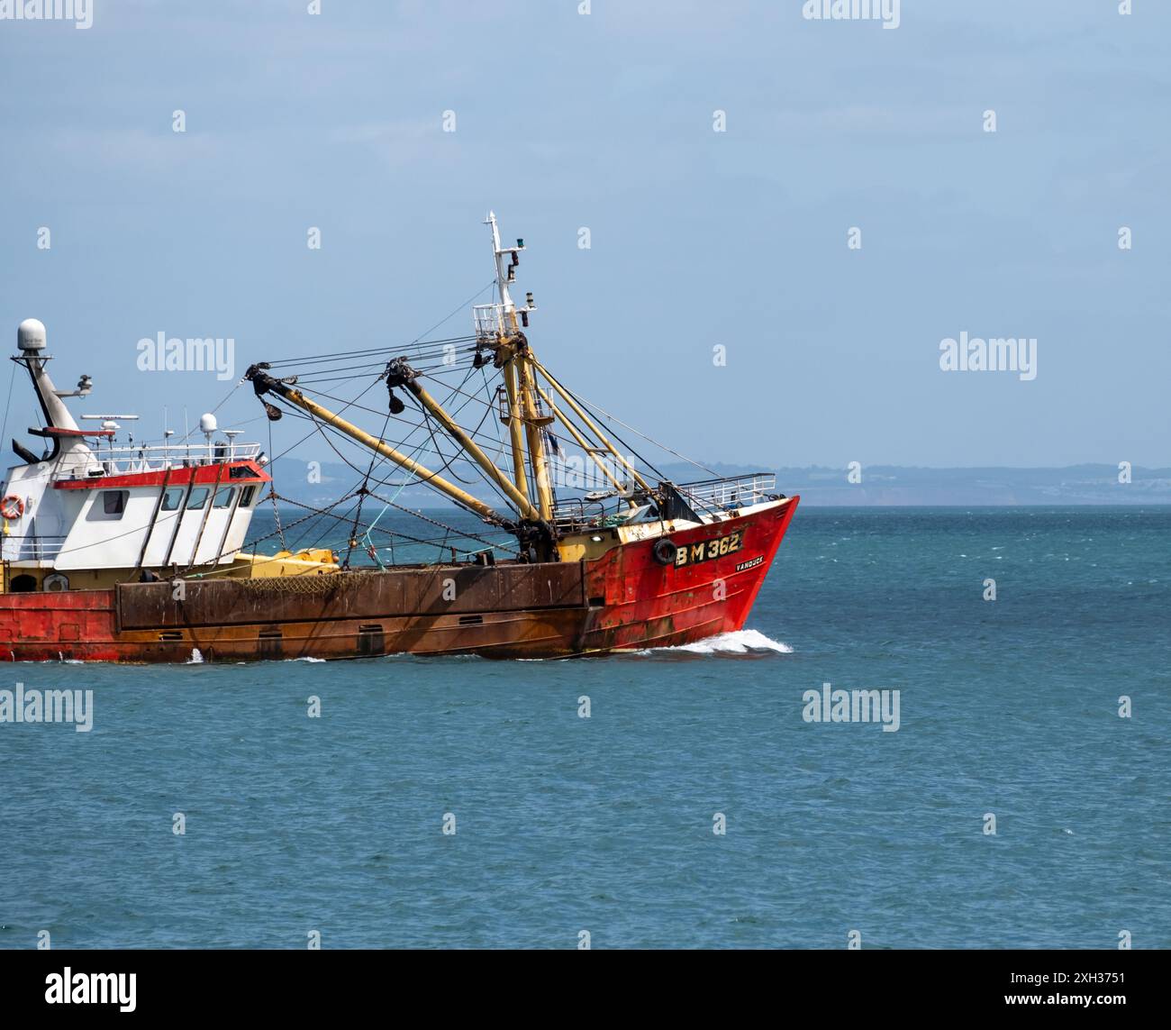 A deep sea fishing trawler leaving Brixham Harbour to embark on a ...