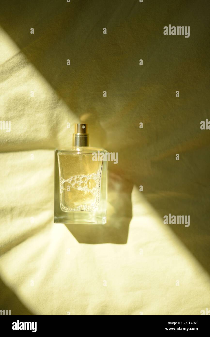 perfume bottle on a yellow background, seen in a sunlight Stock Photo ...