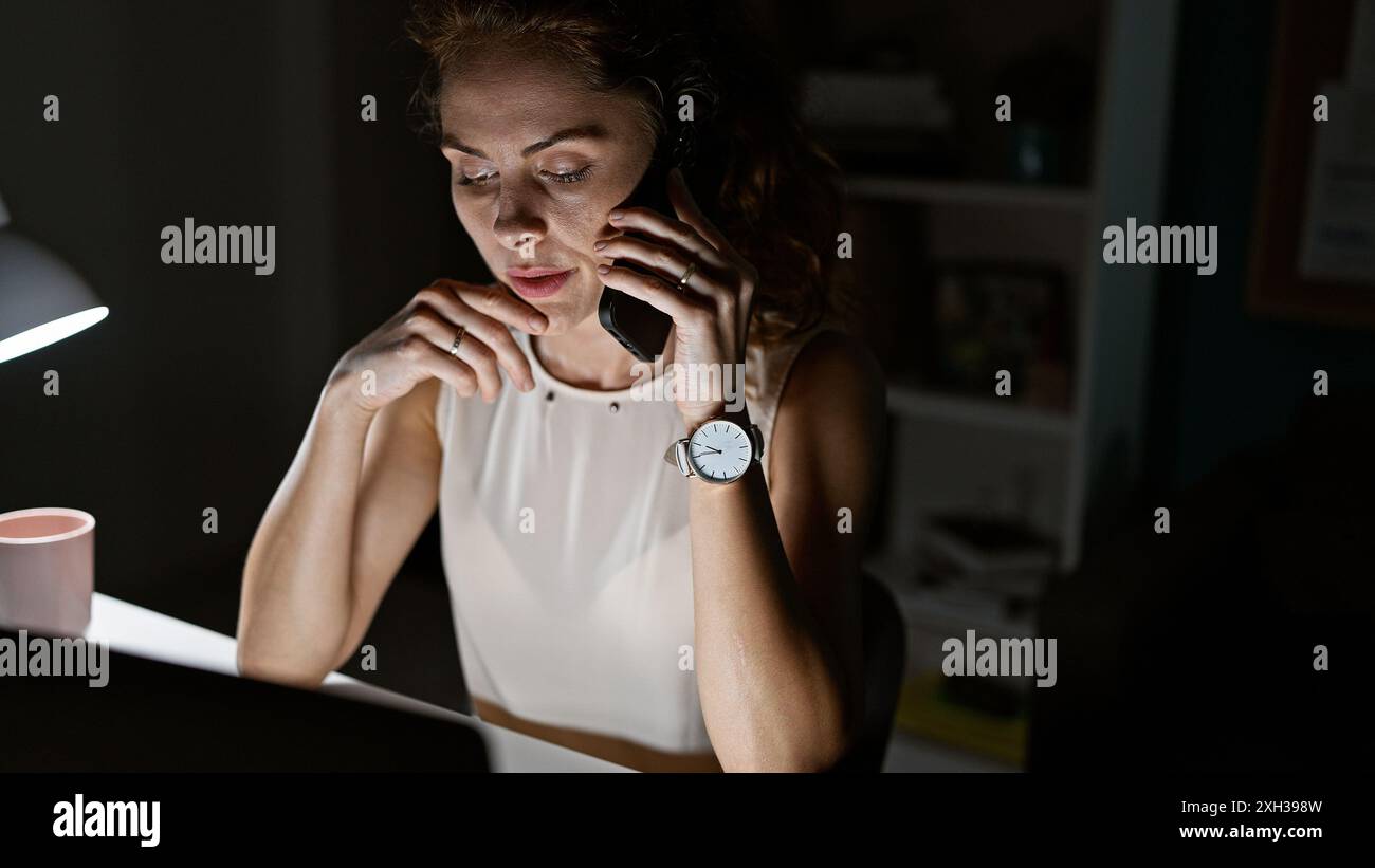 A focused caucasian woman in a sleeveless top is busy with a late-night ...