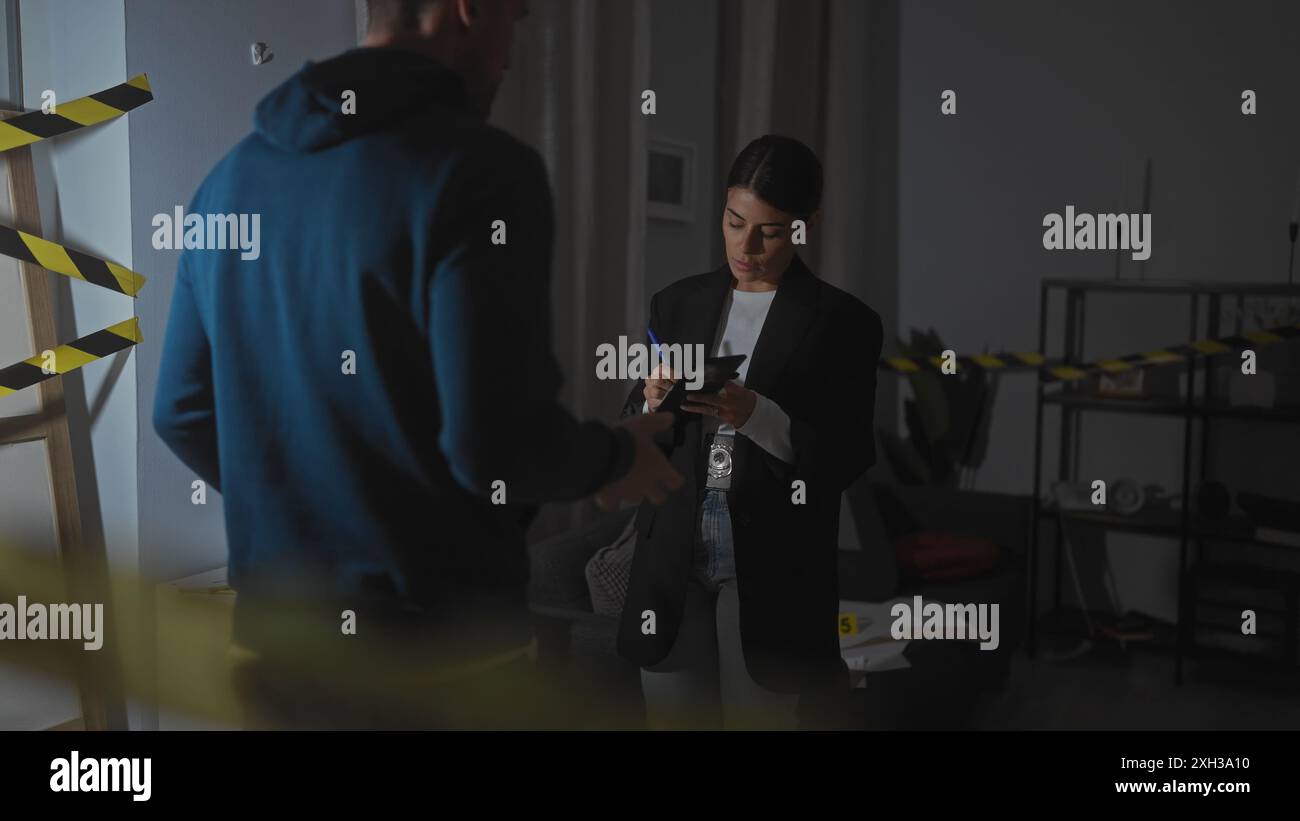 A policewoman investigates a suspicious man indoors at a crime scene ...