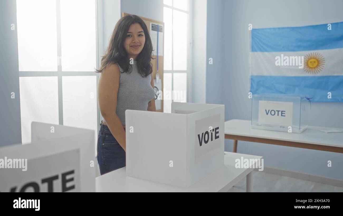 A young hispanic woman is voting in an electoral college room with an ...