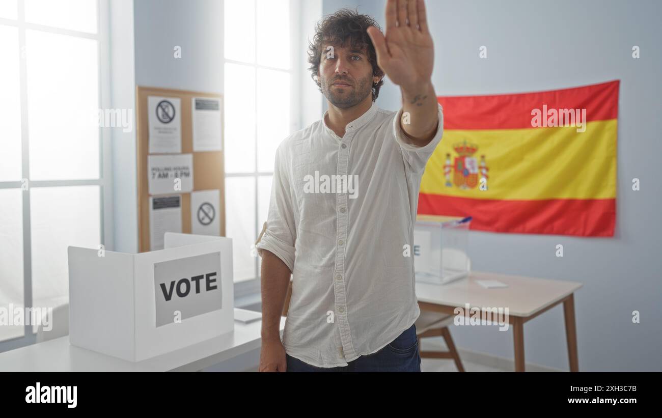 Young man standing in a spanish electoral college room with a voting ...