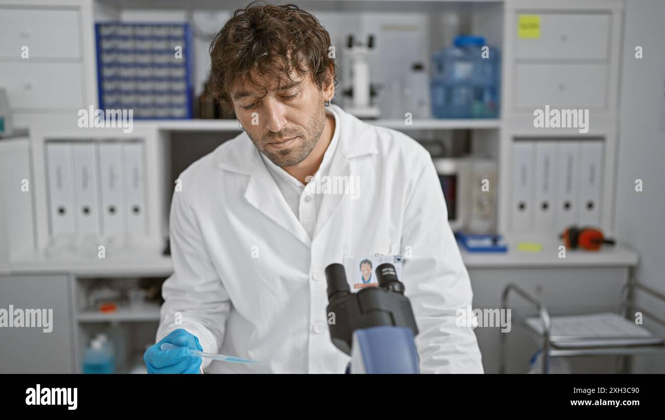 A professional man conducts research at an indoor laboratory, examining ...