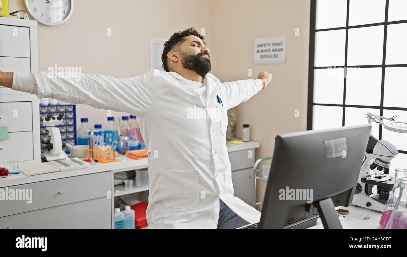 Hispanic man stretching in a laboratory setting with scientific ...