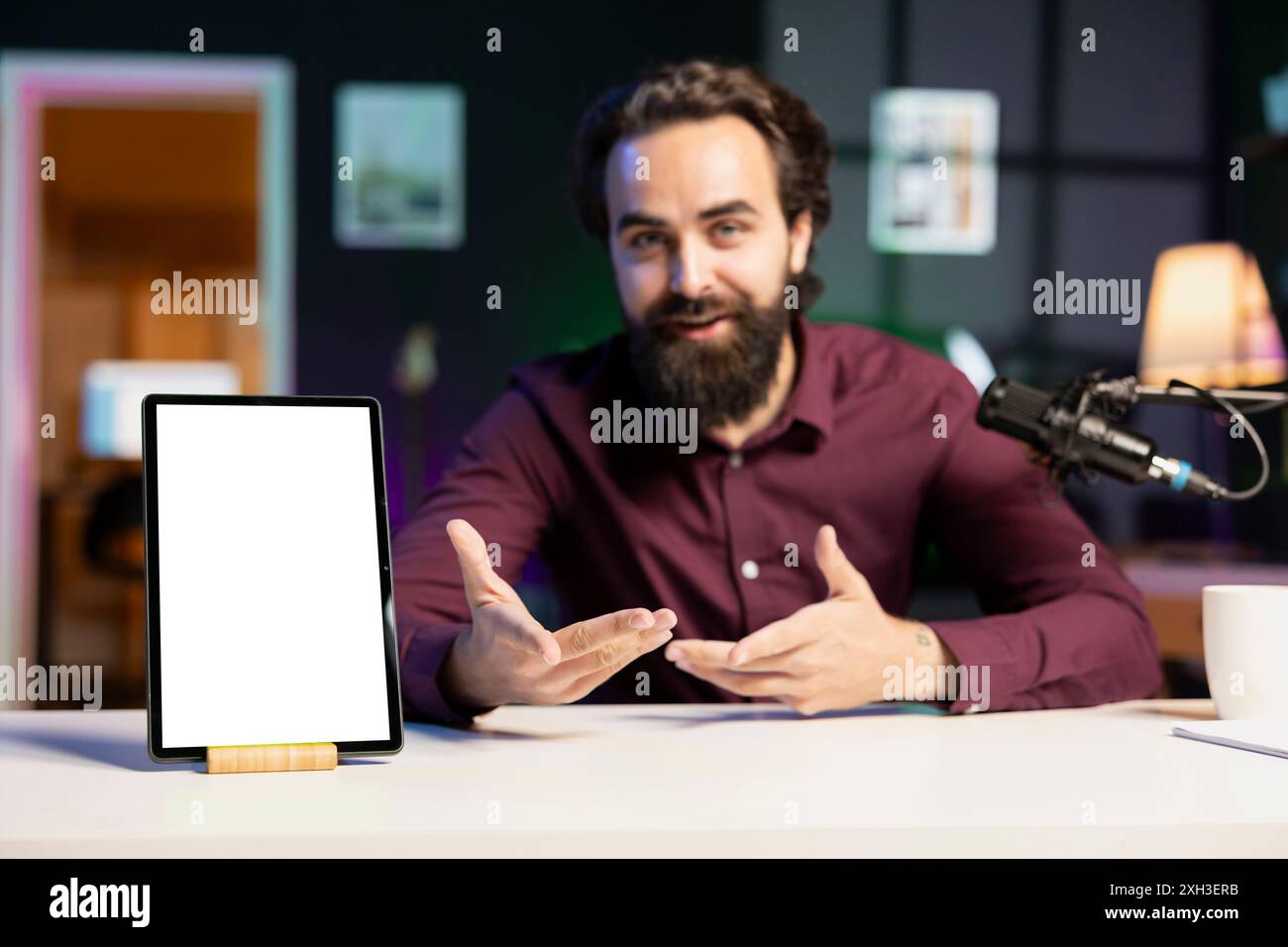 Tech specialist presenting mockup tablet to interested viewers, filming ...