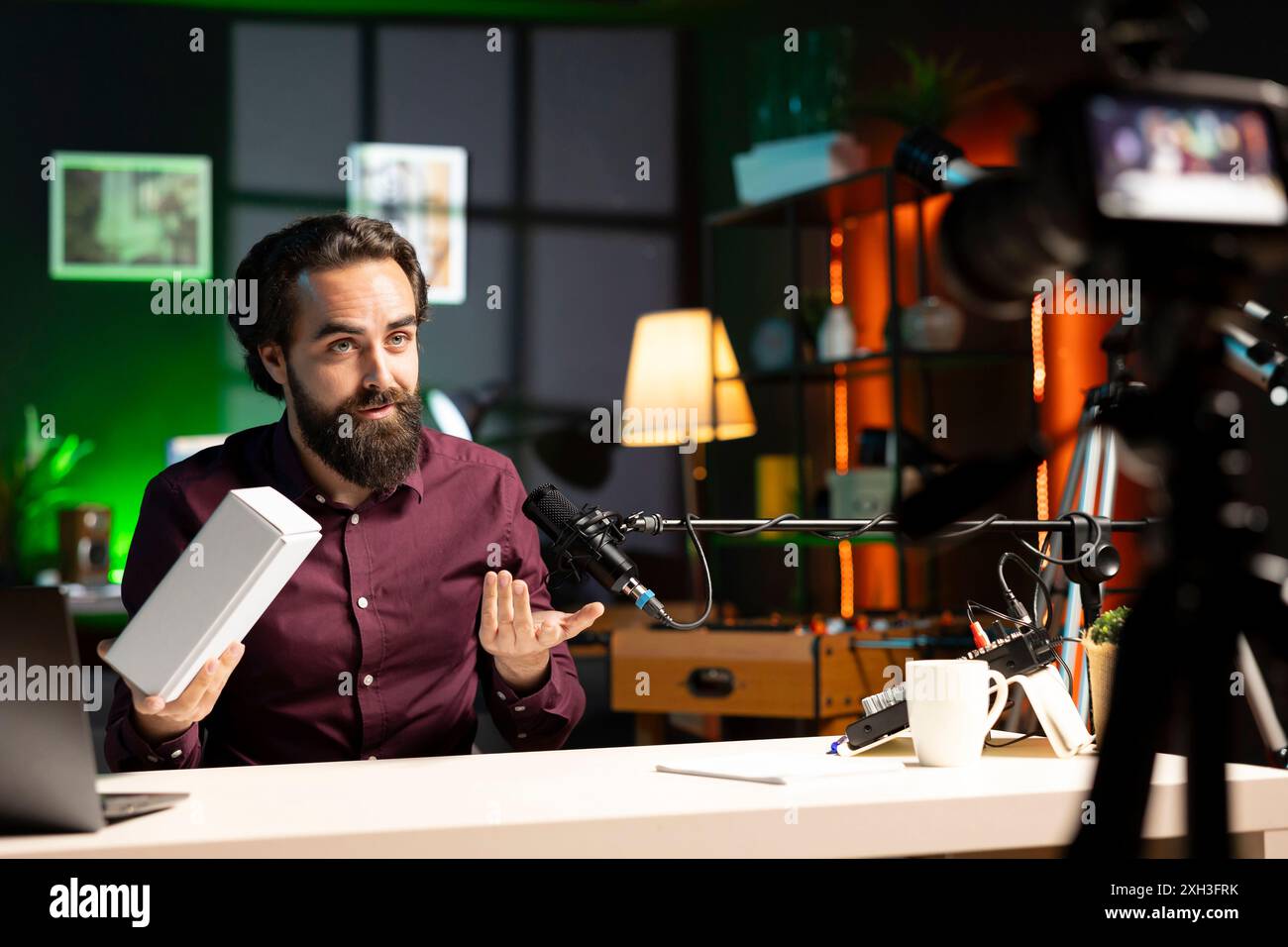 Tech influencer using professional camera and mic to film technology ...