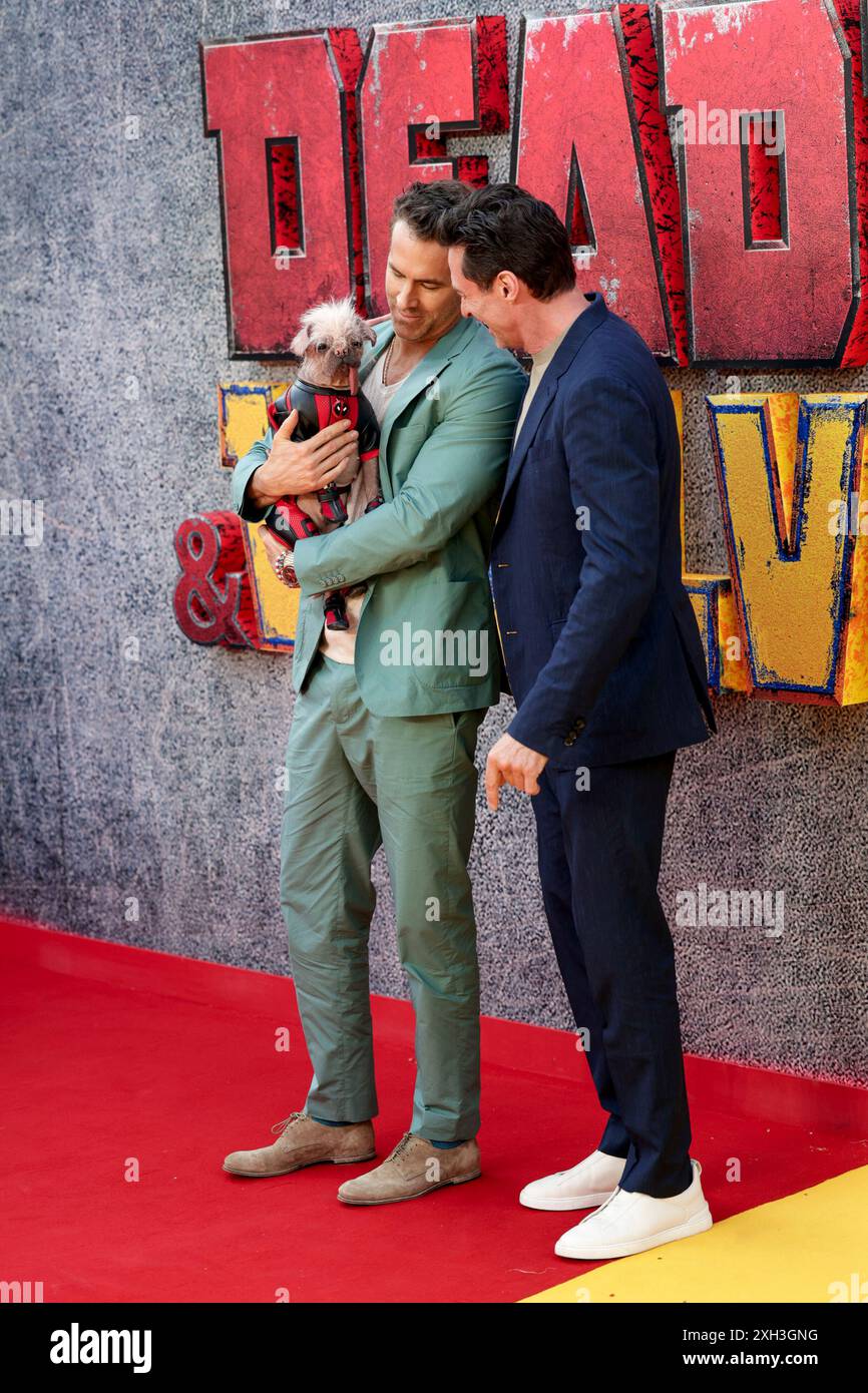 Ryan Reynolds, left, and Hugh Jackman pose with Peggy the dog for ...