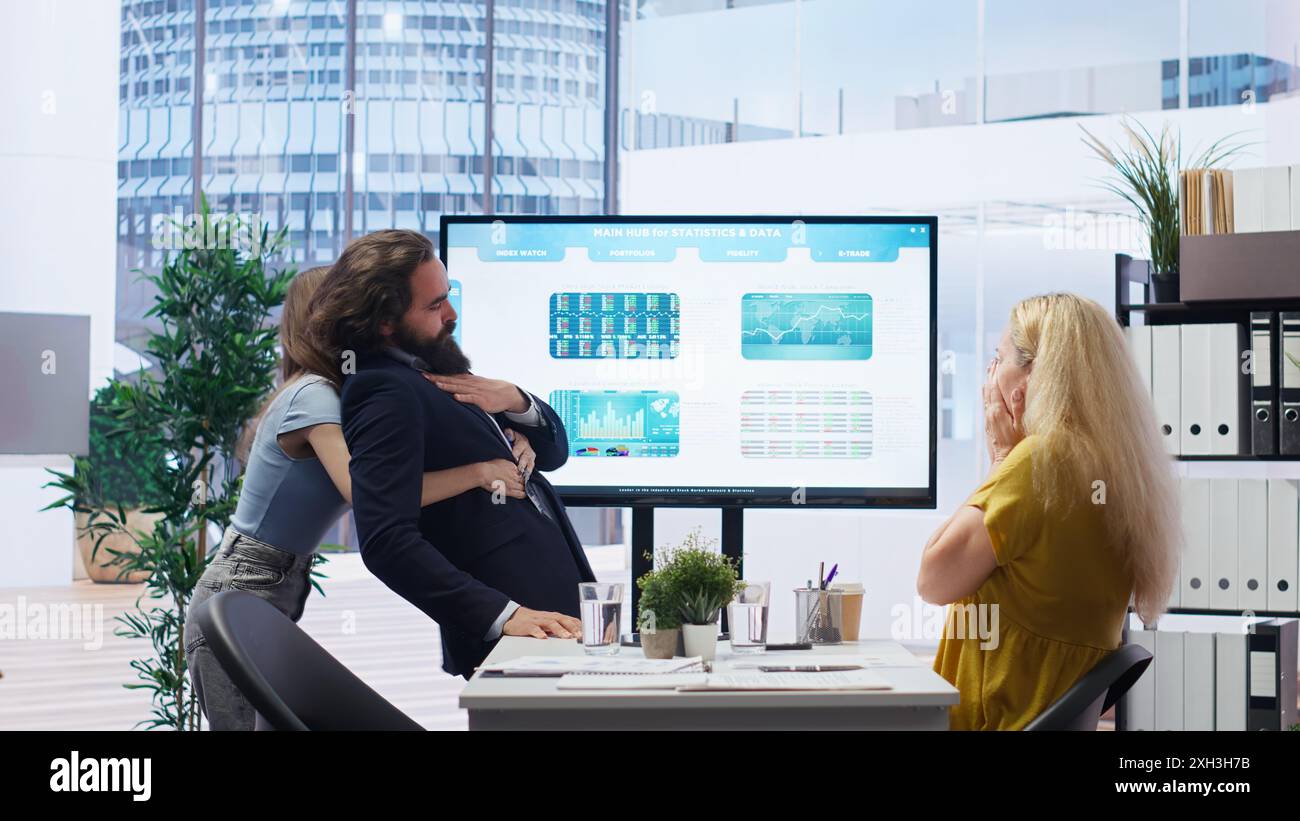 Employee choking in office, being helped by quick thinking coworker ...