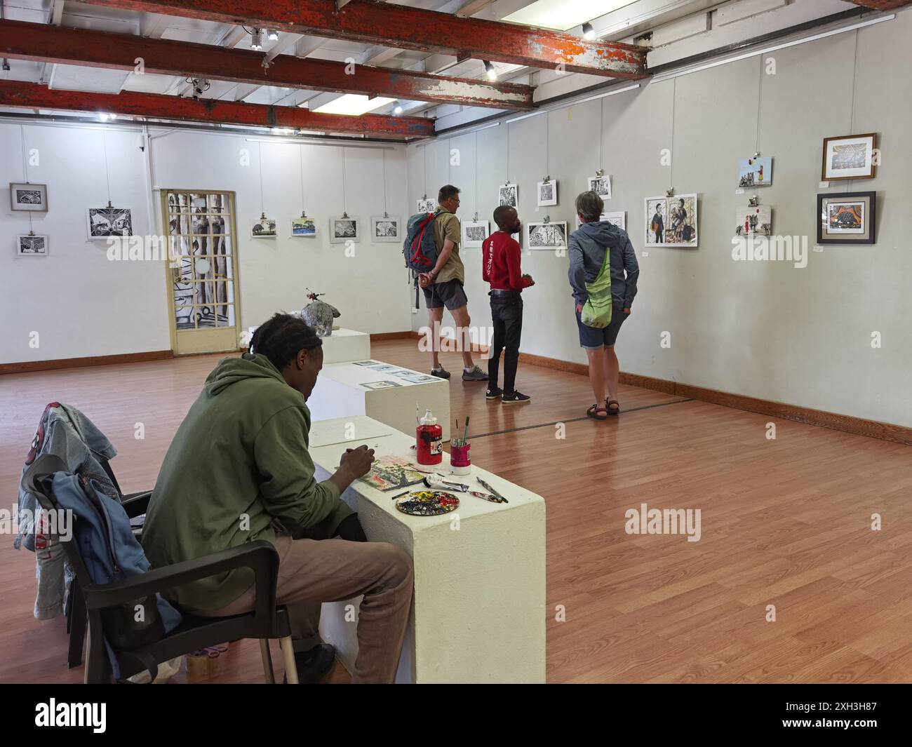 Windhoek, Namibia. 11th July, 2024. An artist draws a painting as ...
