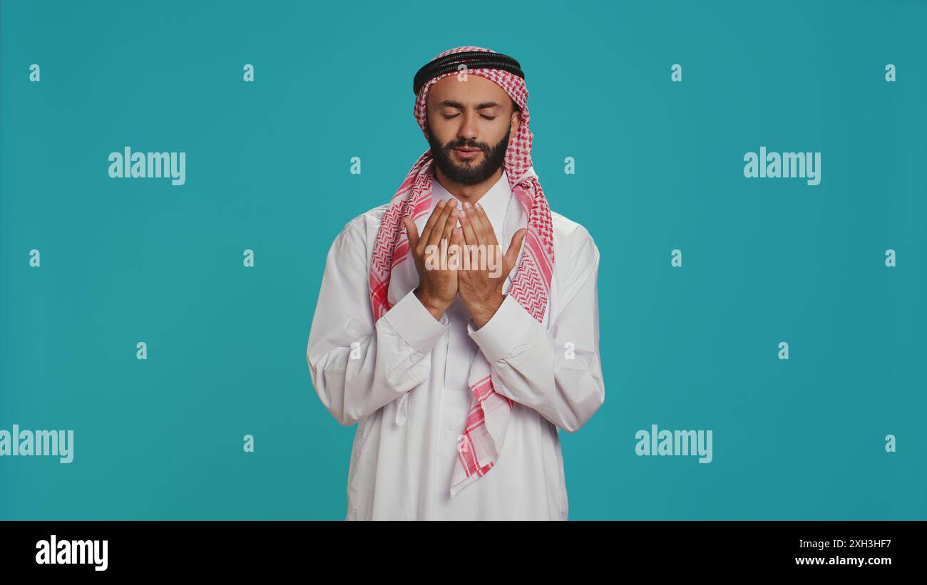 Islamic man praying to allah in studio, having hope in religious ritual ...