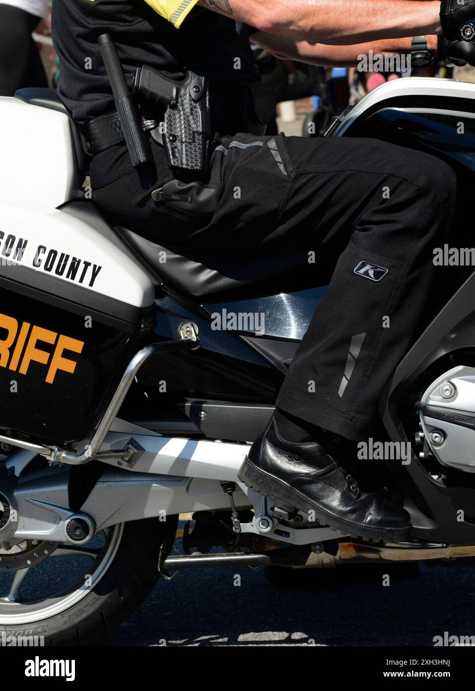 A Henderson County Sheriff's Department officer on a motorcycle patrols ...
