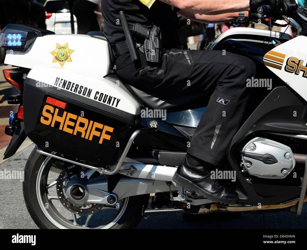 A Henderson County Sheriff's Department officer on a motorcycle patrols ...