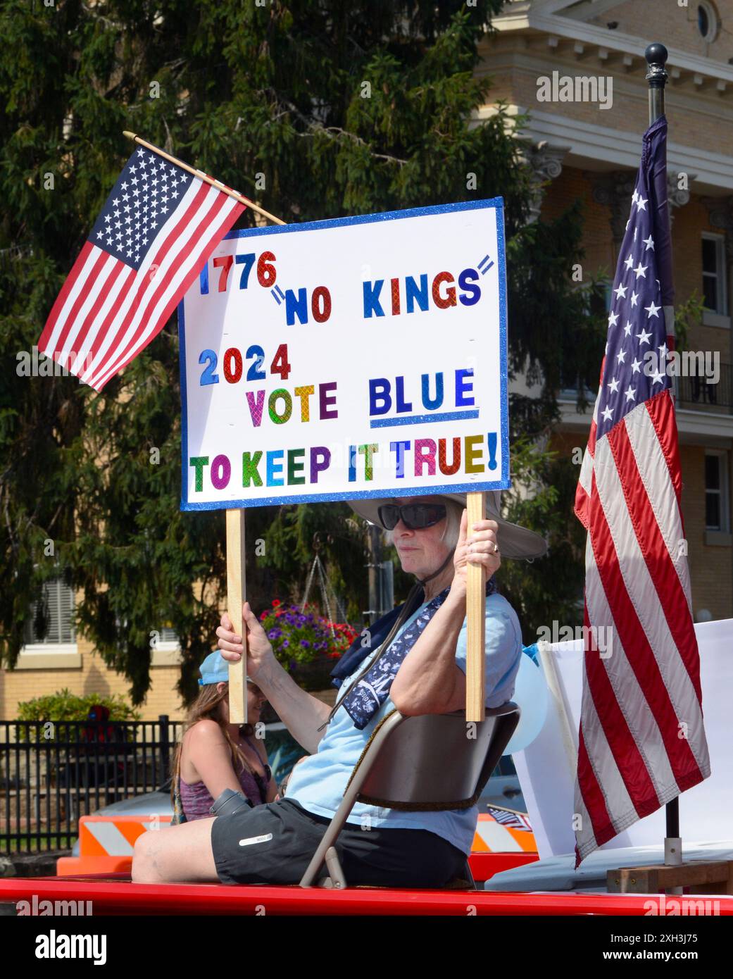 A member of the U.S. Democratic Party holds an anti-Donald Trump sign ...