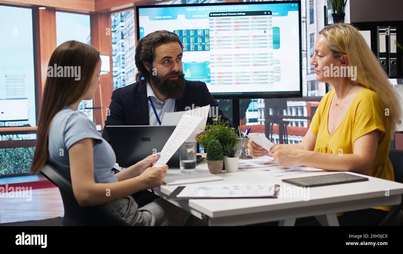 Financial adviser conducting audit of clients income, developing ...