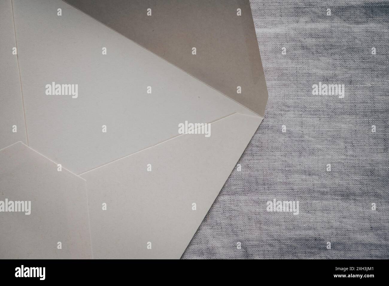 Open envelope on natural off-white linen background. Top view Stock ...
