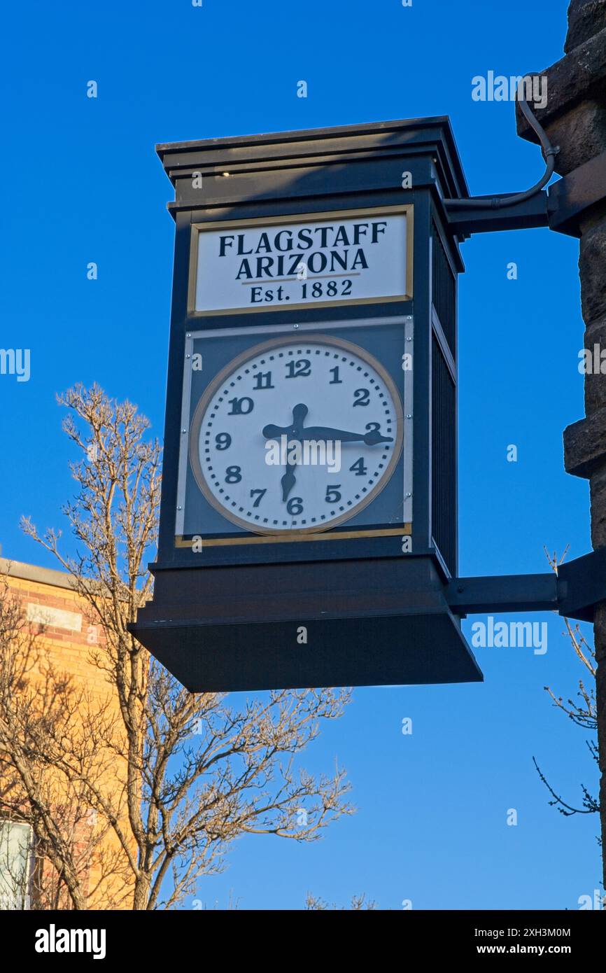 Analog clock hung from building wall in downtown Flagstaff Arizona ...