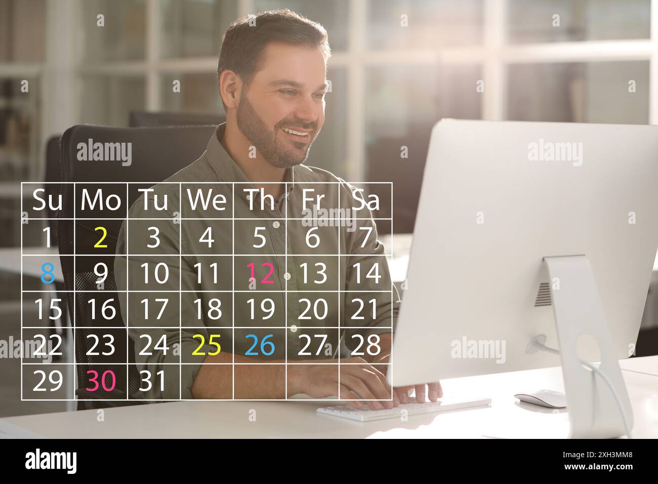 Happy man making timetable in computer. Virtual calendar with marked ...
