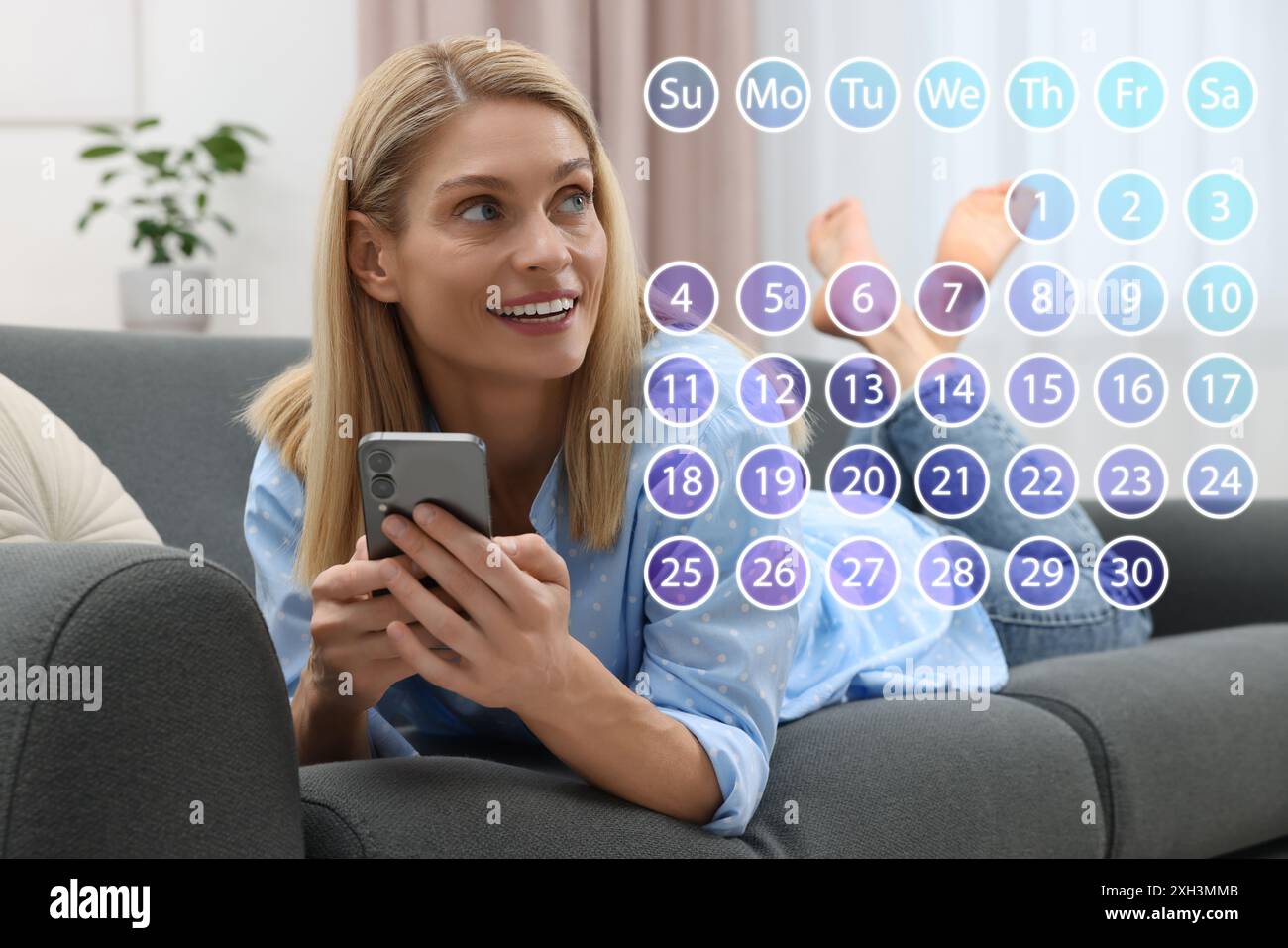 Woman making timetable in phone at home. Virtual calendar near her ...