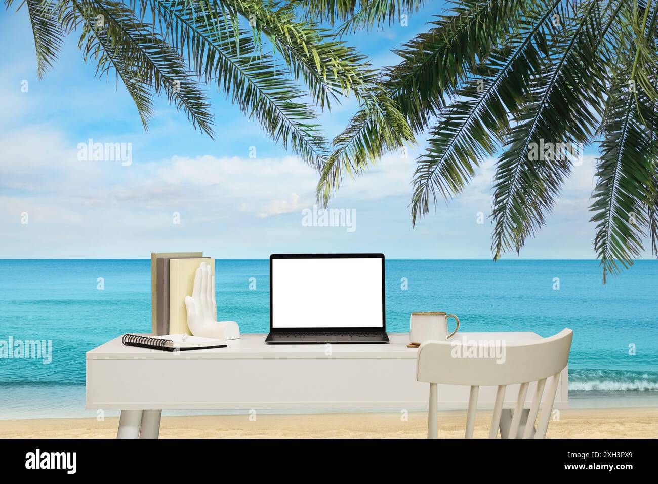 Workplace at beach, distant office. Table with laptop and chair on ...