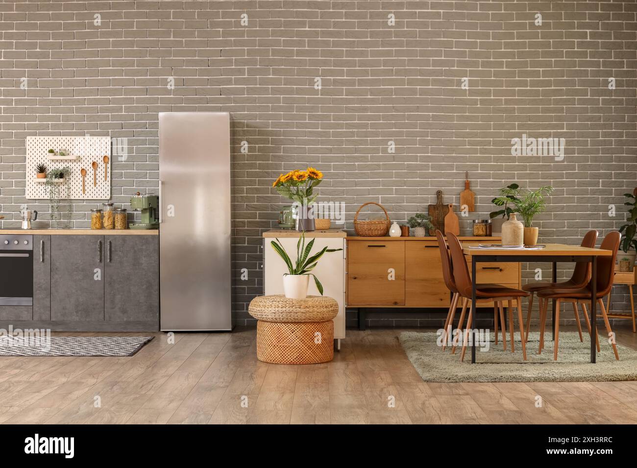 Interior of modern comfortable kitchen with fridge, counter and dining ...