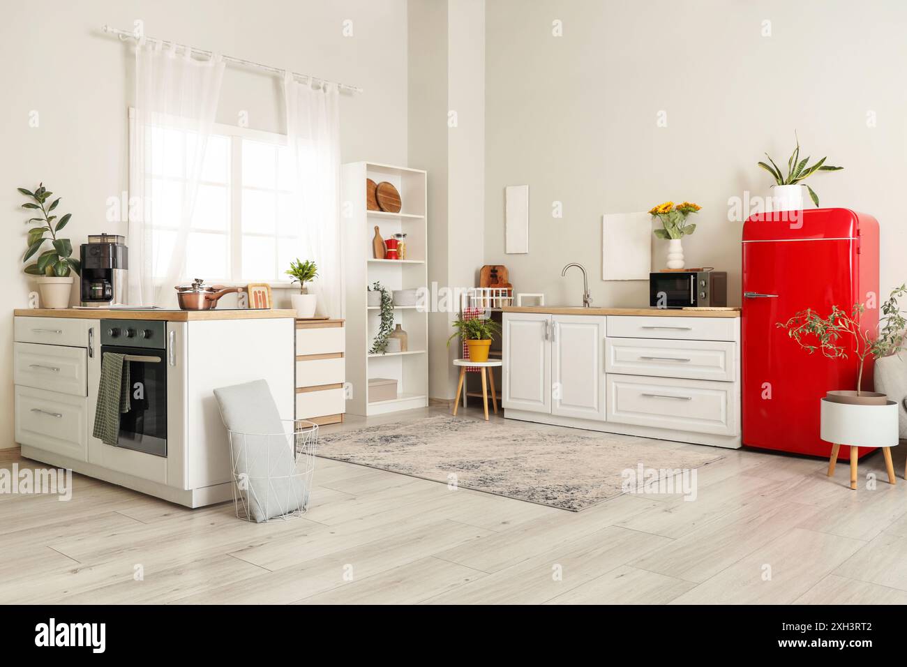 Interior of stylish kitchen with red fridge and white counters Stock ...