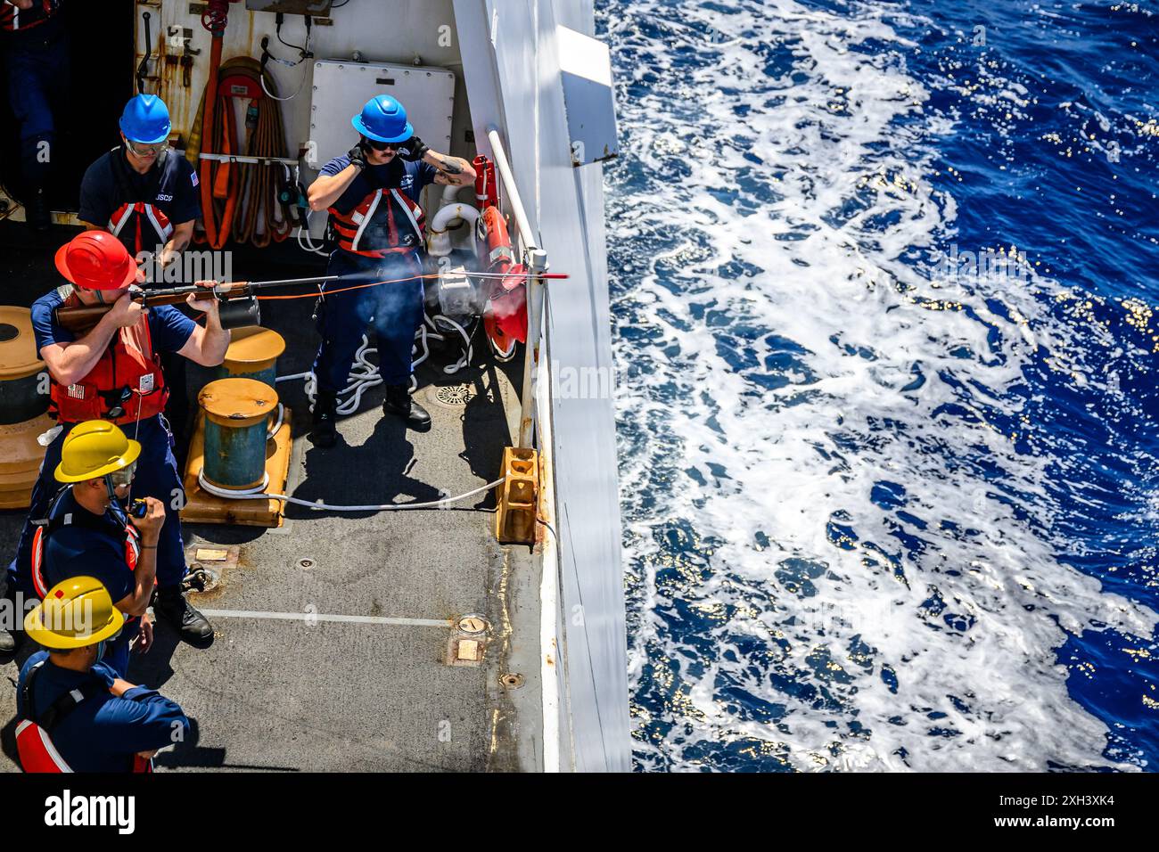 U.S. Coast Guard Gunnery Mate 3rd class Richard-Baker fires a shoulder ...