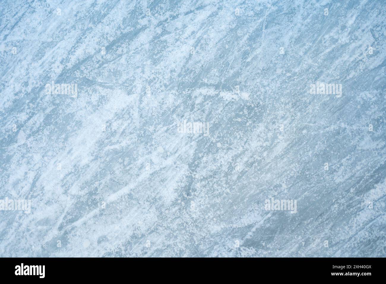 Icy background on rink with visible traces of skating, showcasing the ...