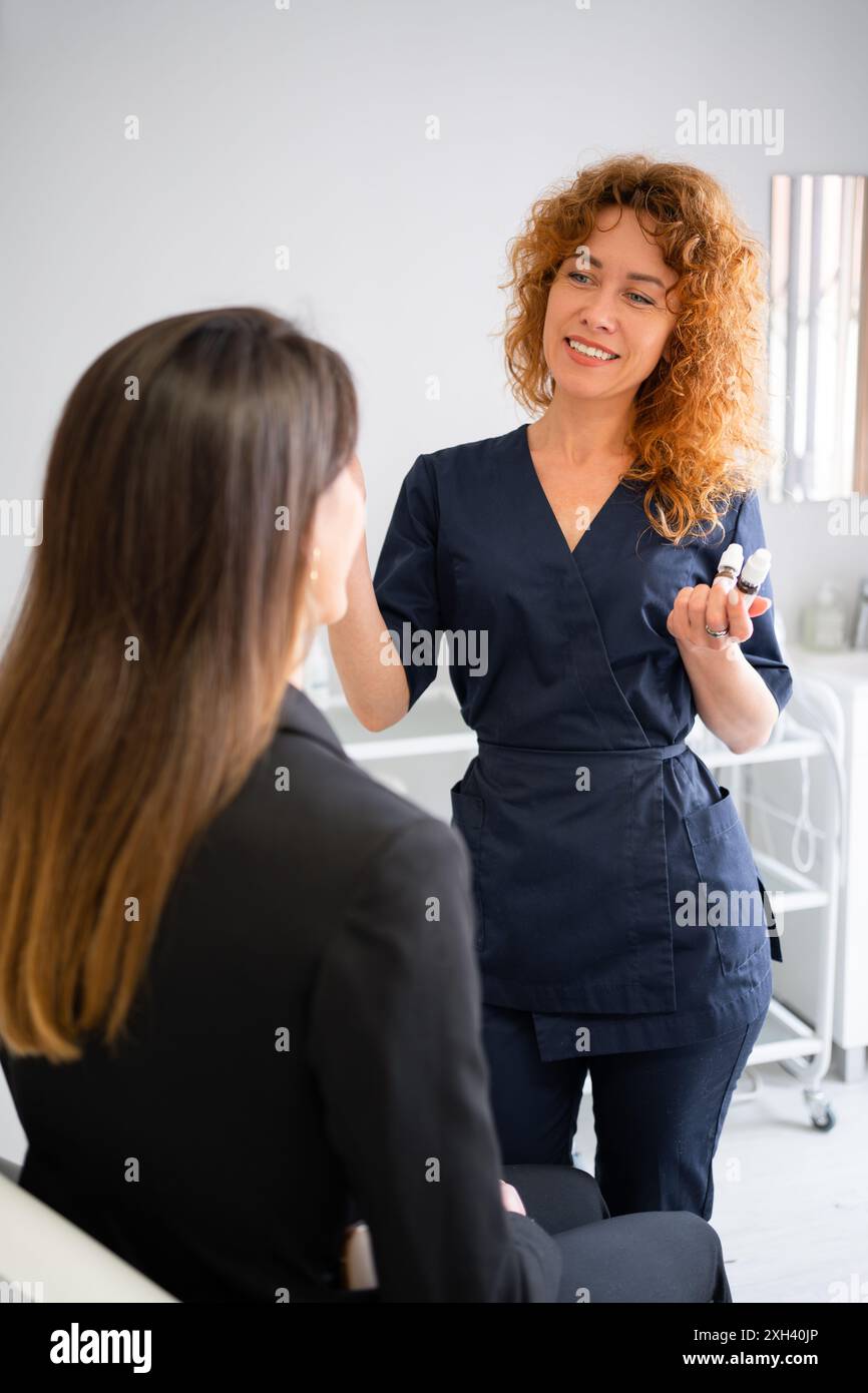 Female professional beauty doctor talking with woman customer. Beauty ...