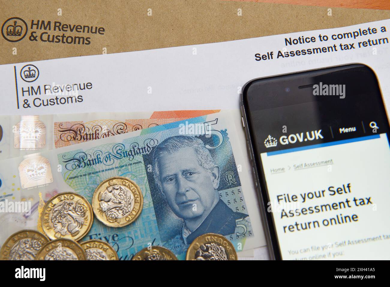 Flat Lay of HMRC Self Assessment Tax sign in and money Stock Photo - Alamy