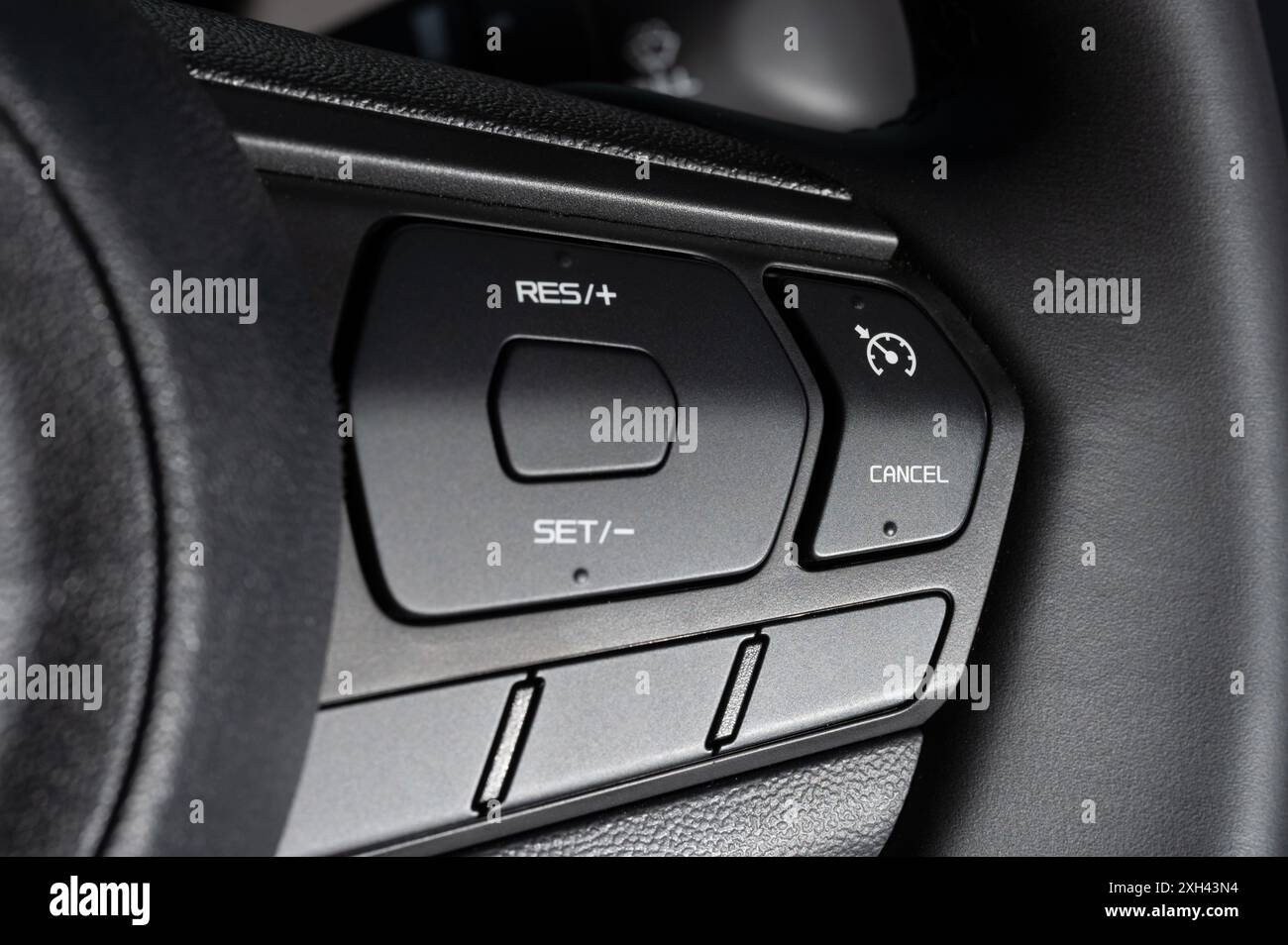 Cruise control buttons on car wheel macro close up view Stock Photo - Alamy