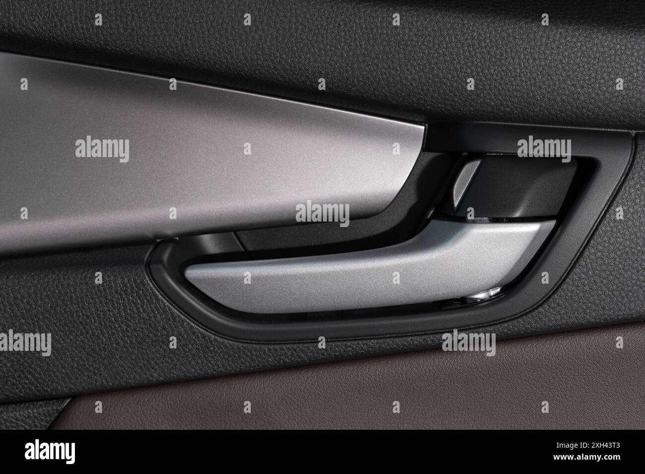Car door lock handle in leather inside close up view Stock Photo - Alamy